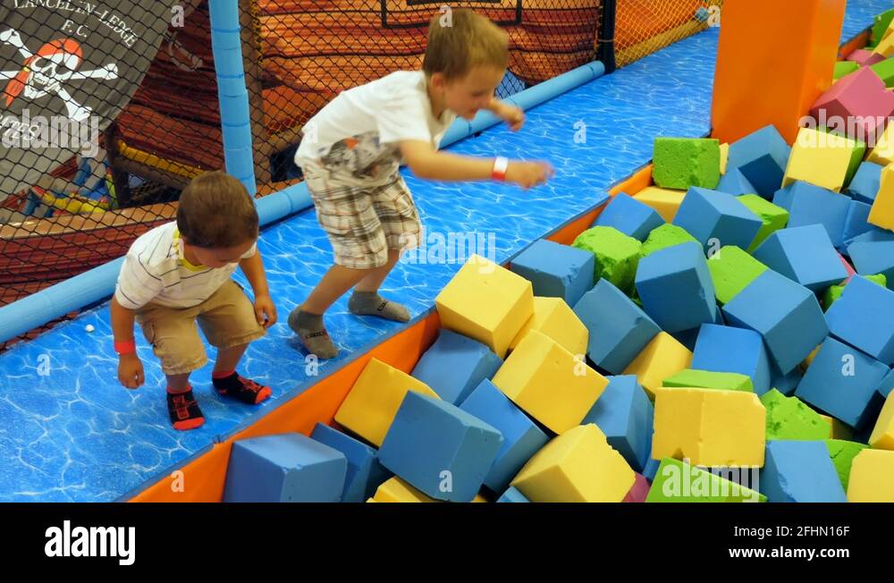 Boys playing in the soft foam pit in a jump house Stock Video Footage ...