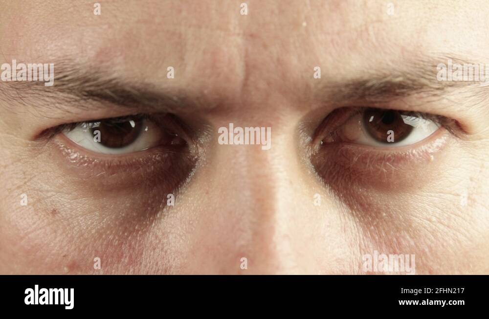 Extreme close up of man eyes looking furious and angry Stock Video ...