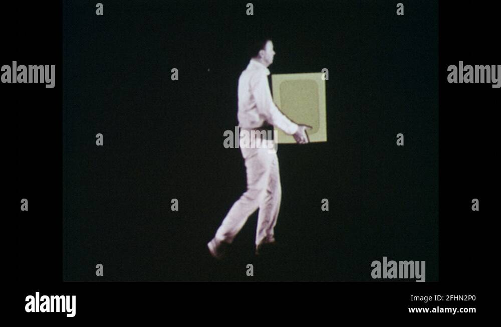 1960s: Animated man carries box to cartoon table. Man shoves box onto ...