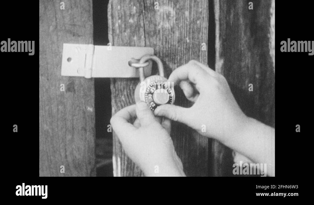 1950s: Hands turn dial on combination lock and open it. Boy opens trunk ...