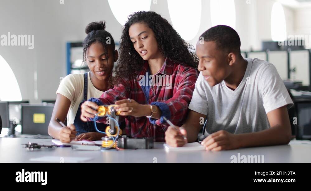 High school students working on a robotic arm in class Stock Video ...