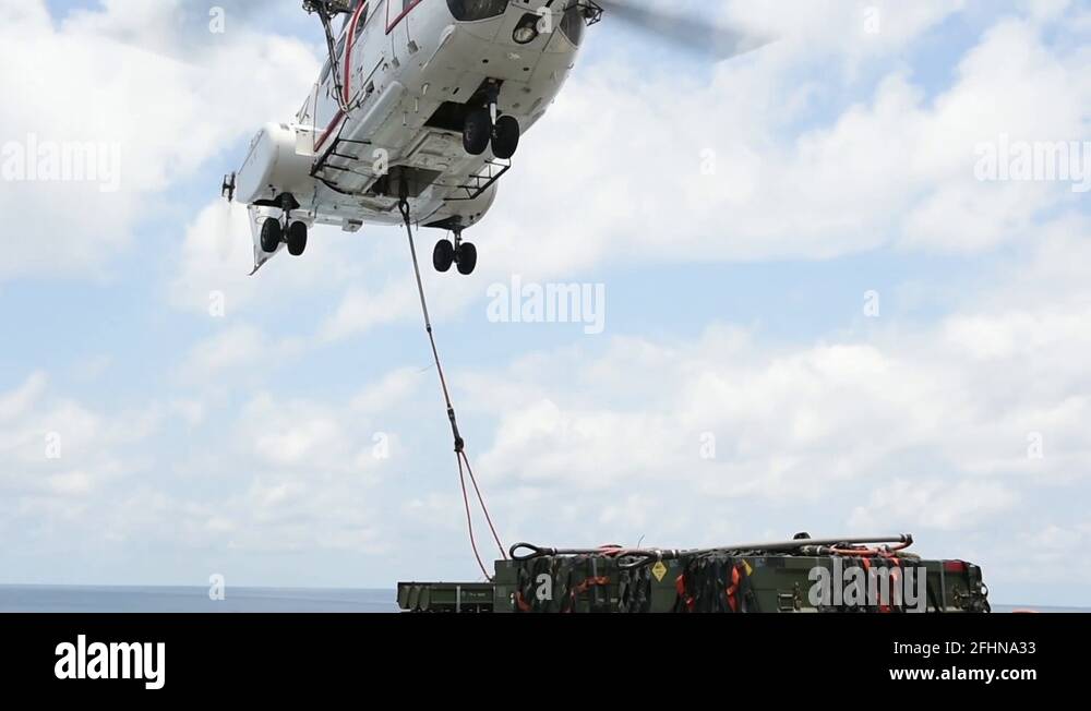 Helicopter sling load the carrier from the flight deck of USS Boxer ...