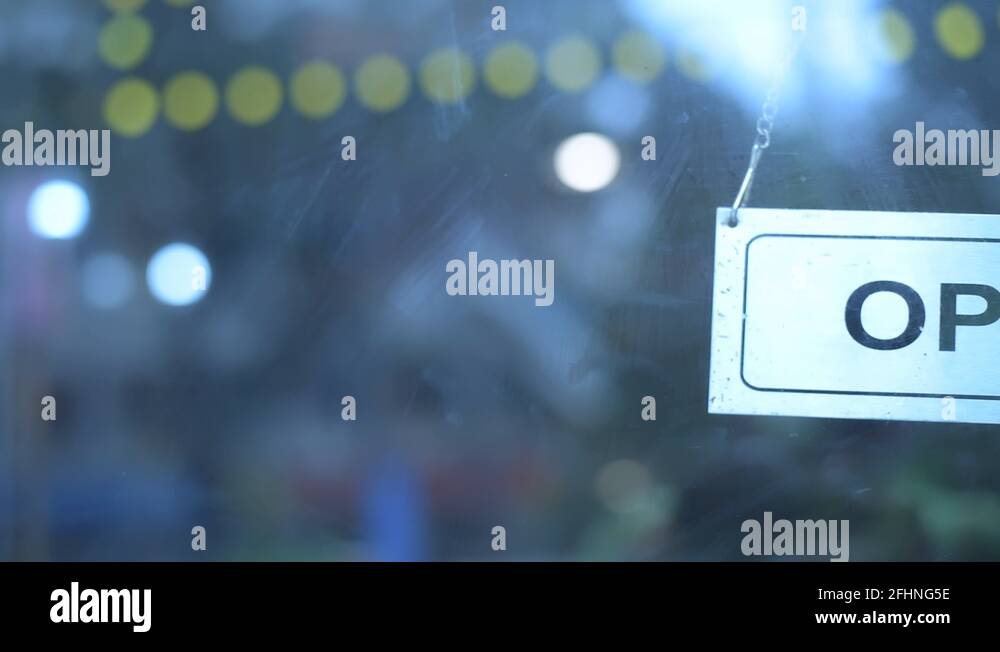 Slow pan of Open Sign board at a glass door of a restaurant, shop, bar ...