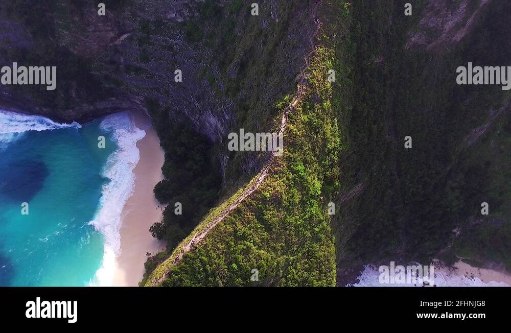 the winding cliff stair case of the famous kelingking beach dinosaur ...