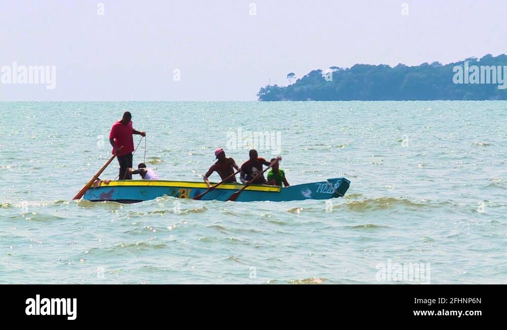 traditional African fishermen rowing in a dugout canoe (pirogue) in ...