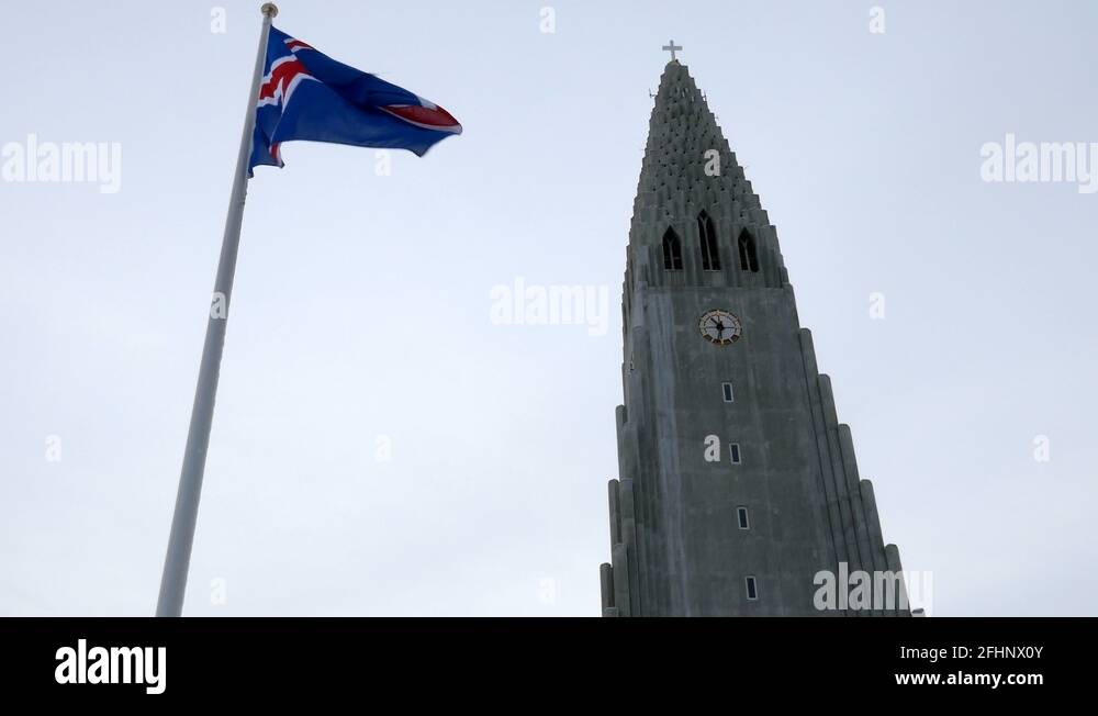 Flag of Iceland waving in wind in front of Hallgrimskirkja the symbol ...