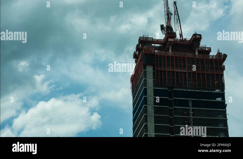 Building under construction with rain clouds background in Bangkok ...