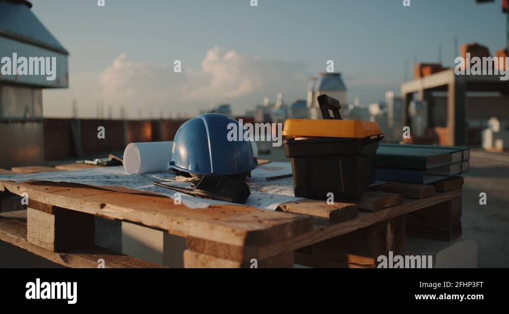 Closeup in rooftop of building , work desk with plan of construction ...