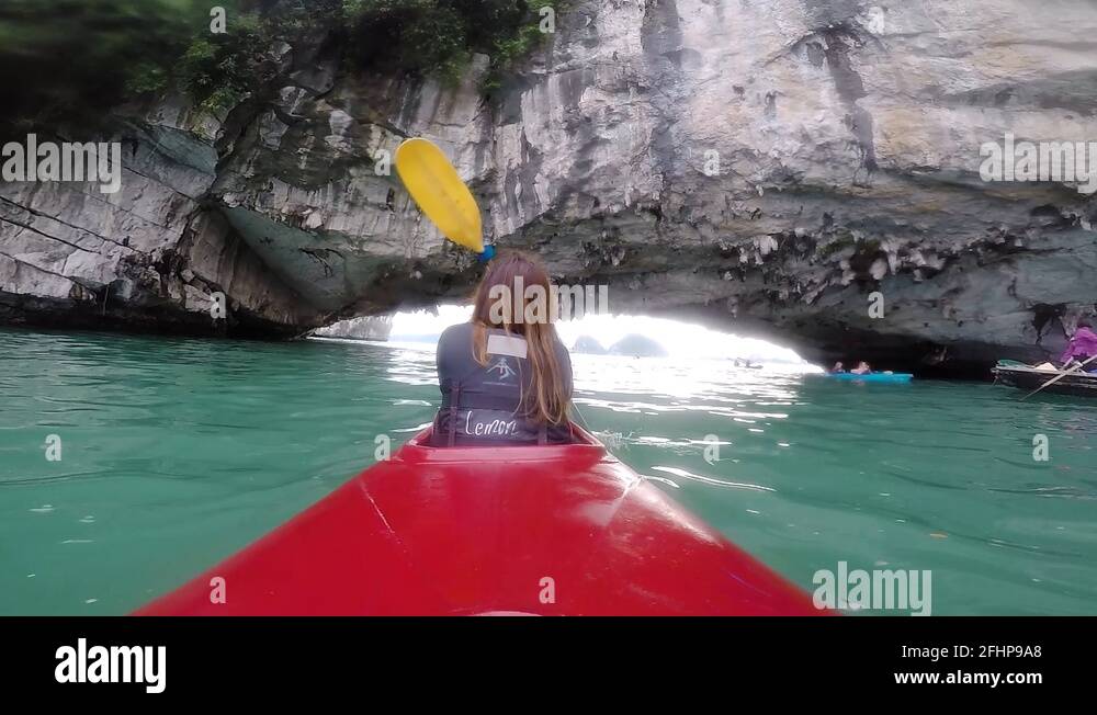 A girl kayak into a cave Stock Video Footage - Alamy