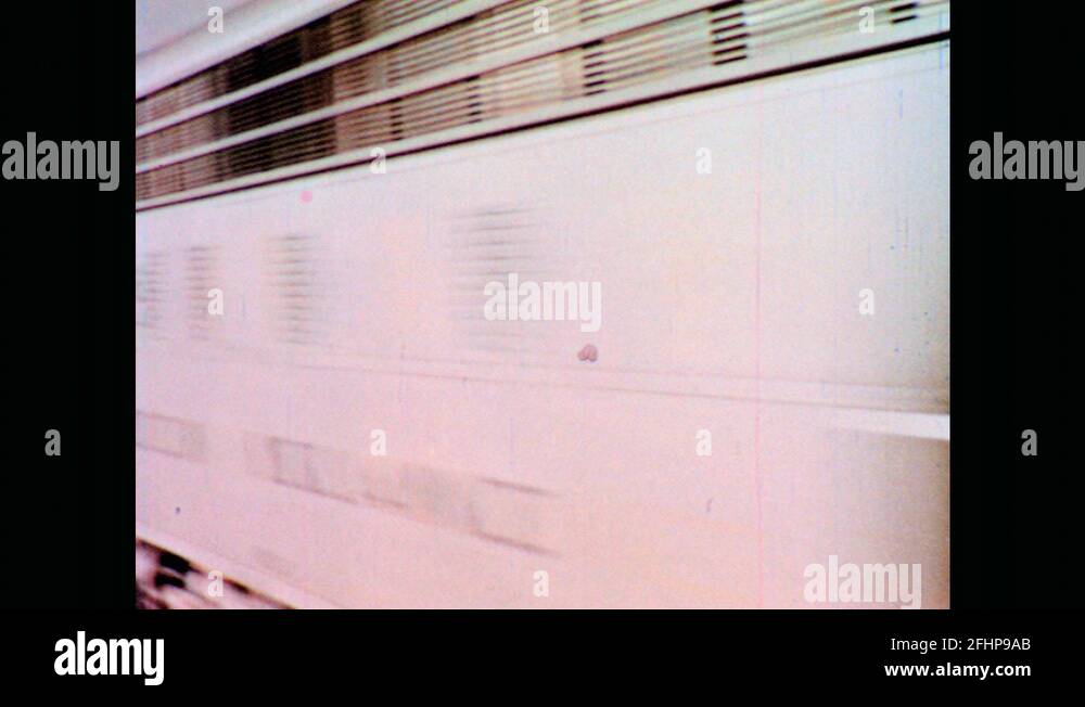 1960s: UNITED STATES: side profile of train carriages. View of tracks ...
