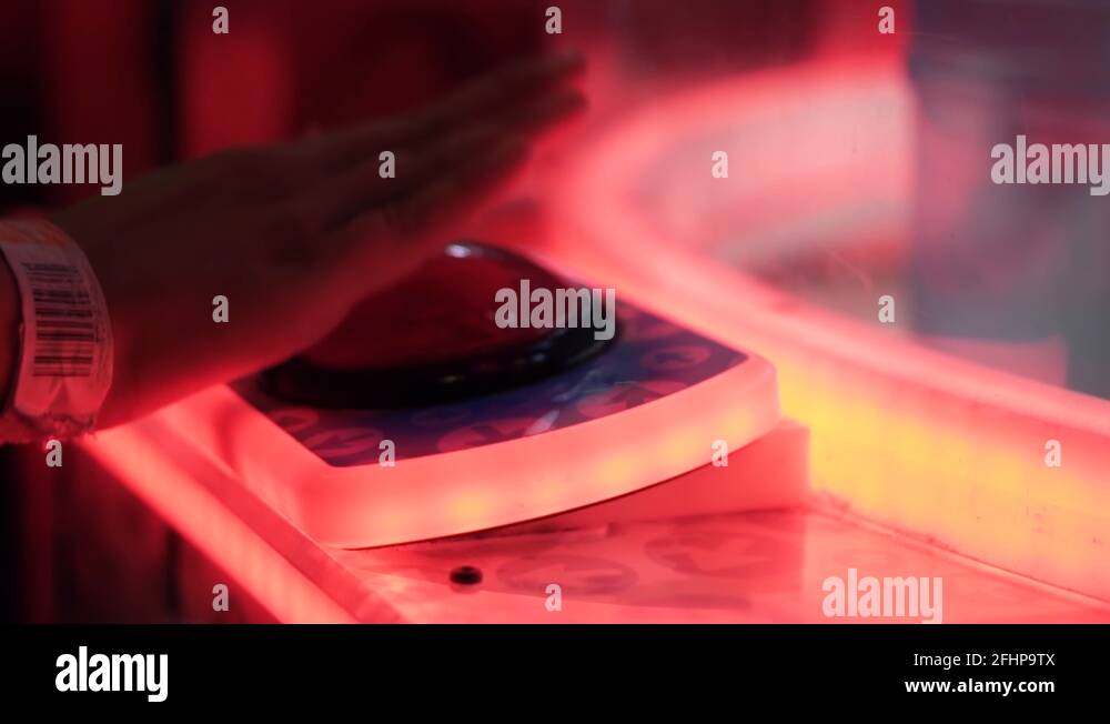 A slo-motion, side angle of a hand smashing the big red button on an ...