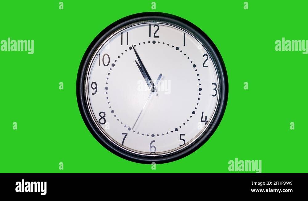Hyper-lapse of a simple modern wall clock in front of a green screen ...