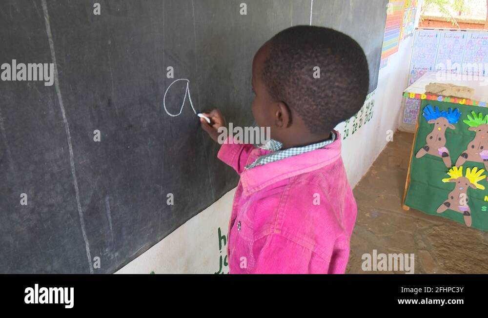 African Kids learning alphabet with School Teacher, in a small nice ...