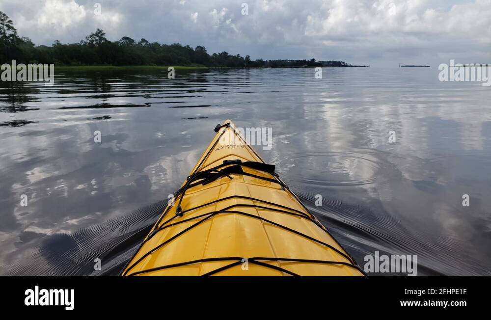 Kayaking the intracoastal waterway in a yellow kayak with smooth water ...