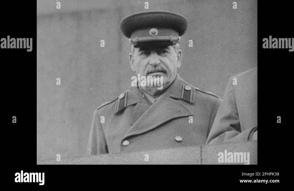 1950s: UNITED STATES: Joseph Stalin stands before camera. Statue of ...