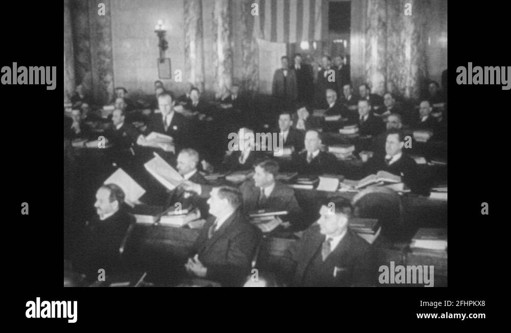 1940s: UNITED STATES: government sits in session. Man gathers papers ...
