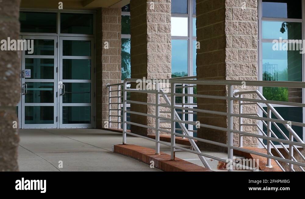 College filler shot - an attractive student enters a modern university ...