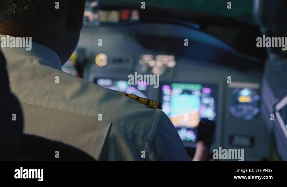 Captain is controls the airplane, rear view Stock Video Footage - Alamy