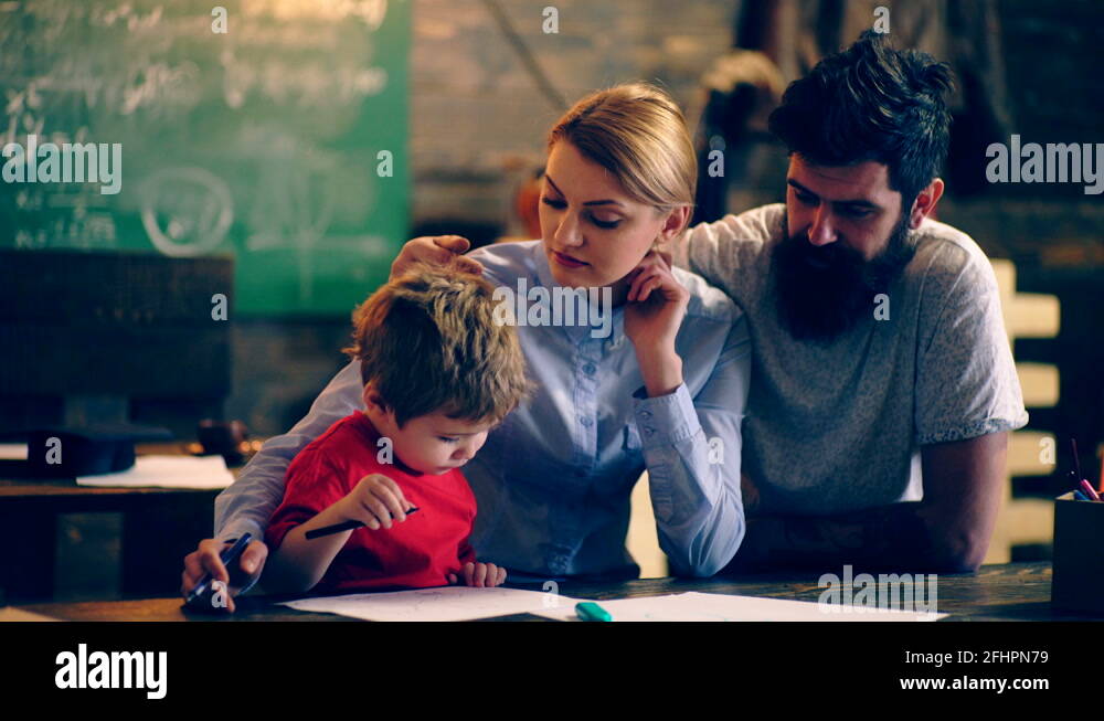 The boy shows his drawings to parents in the school class Stock Video ...
