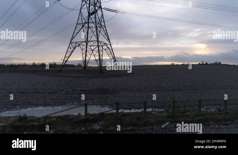 Ascending to reveal large pylon and town in distance, Drone, Yorkshire ...