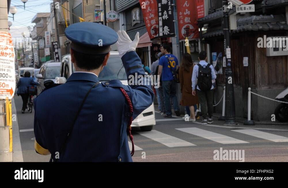 Traffic control police officer on Kyoto street, near Fushimi Inari ...