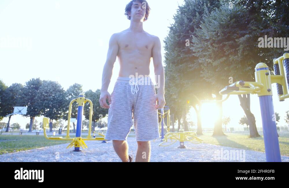 Young bodybuilder walk through outdoor gym in slow motion 4K Stock ...
