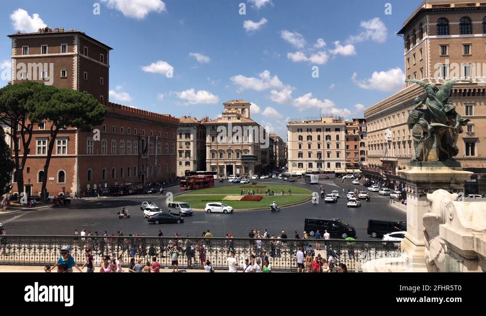Busy roundabout with cars, passing tourists and sightseeing bus, in ...