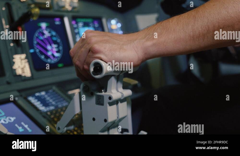 Pilot holding hand on the thrust lever handle for engine control of ...
