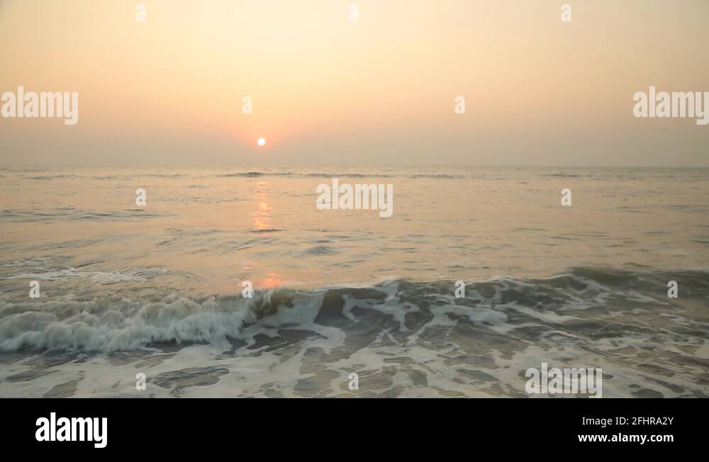 Young girl enters the sea with her back and going away from the ocean ...