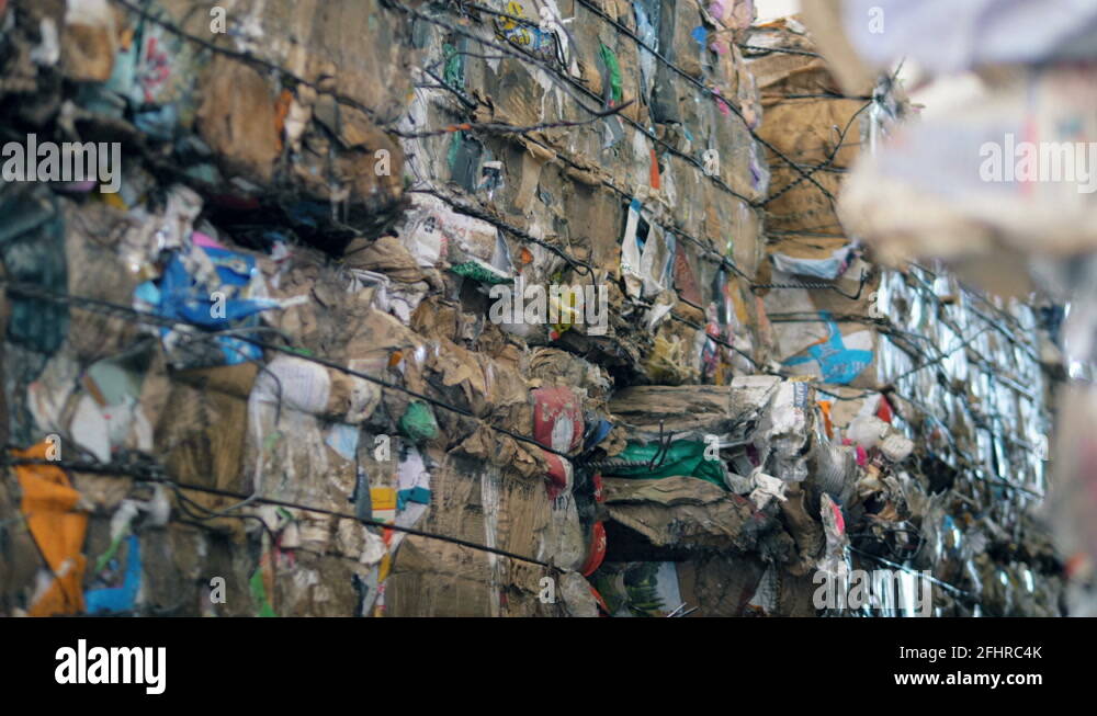 Blocks of rubbish contained in a recycling facility. Waste recycling ...