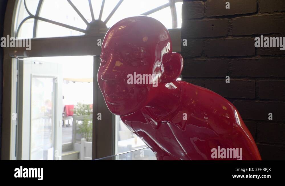 Statue of a red greeting man seen in a Chinese restaurant Stock Video ...