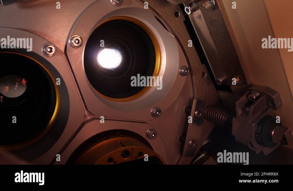 The lens of a cinema projector in a movie theater - close up view Stock ...
