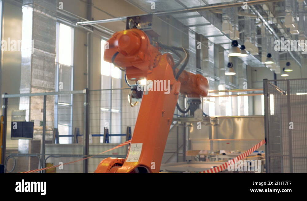 Modern robotic arm works in a factory floor Stock Video Footage - Alamy