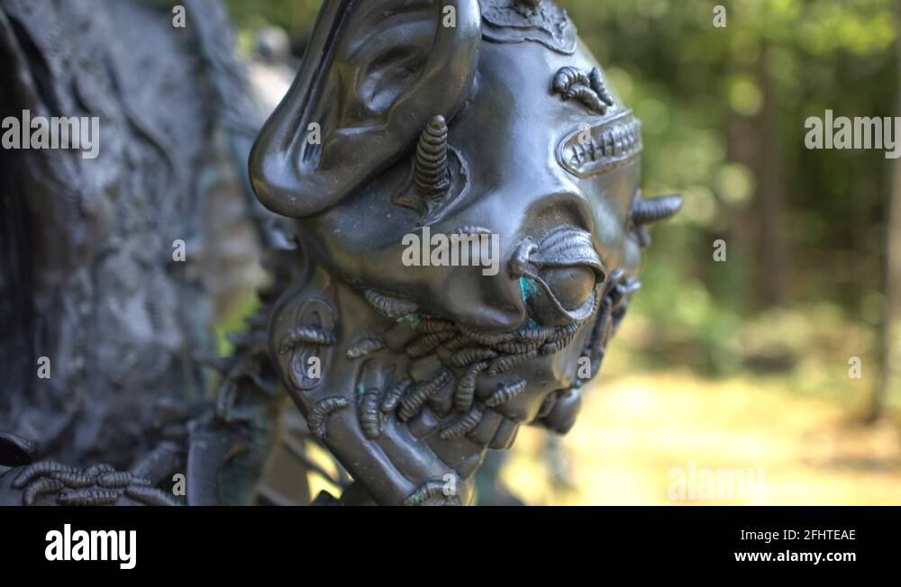 Apocalyptic sculpture made of black metal hell with skeletons and warms ...