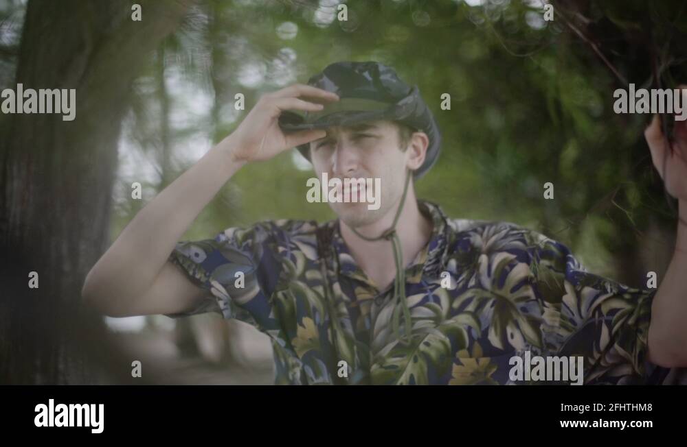 Young white man explores tropical jungle. Wearing Tilly hat and ...