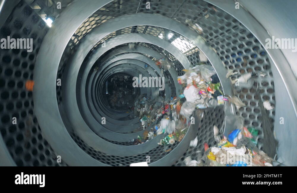 Garbage recycling machine during working process. Garbage sorting plant ...