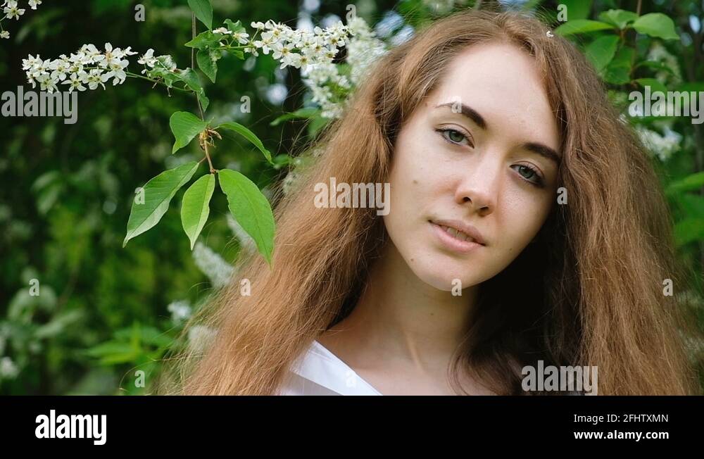 Portrait of a European girl with long flowing hair in nature, slow ...