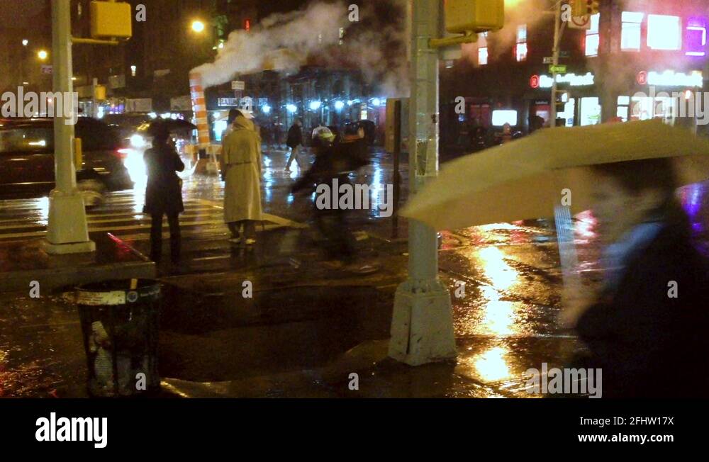 Massive puddle floods a busy city intersection as workers and people ...