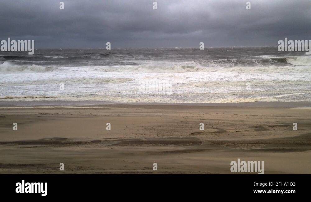 Stormy weather at the beach shows moody clouds and choppy waves Stock ...
