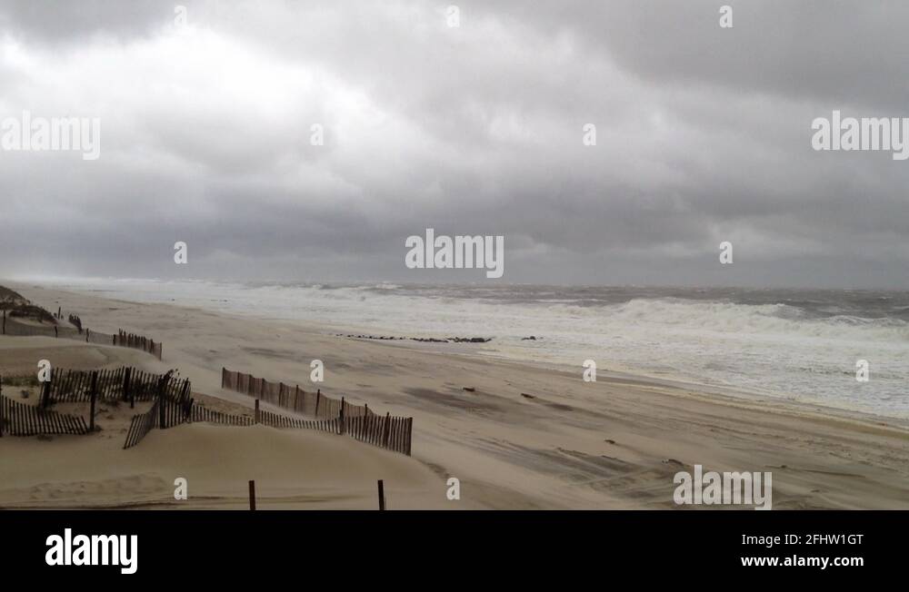 Stormy weather at the beach shows moody clouds and choppy waves Stock ...