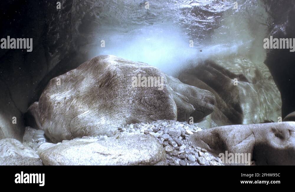 Huge smooth stones and rocks underwater of transparent river Verzasca ...