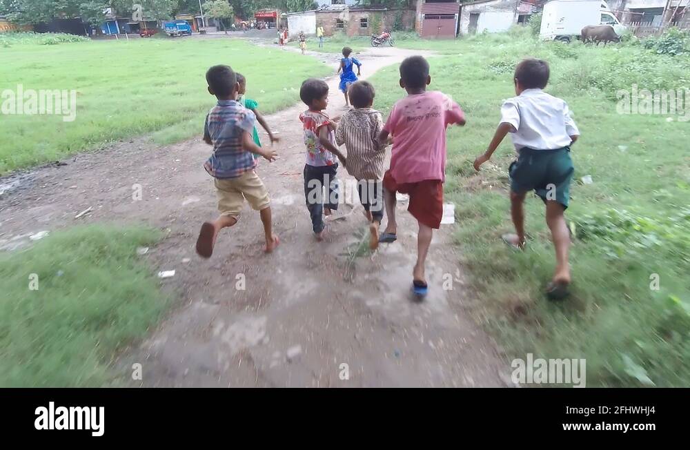 Poor little innocent Indian homeless children playing and running with ...