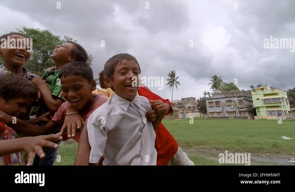 Poor little innocent Indian homeless children playing and laughing with ...