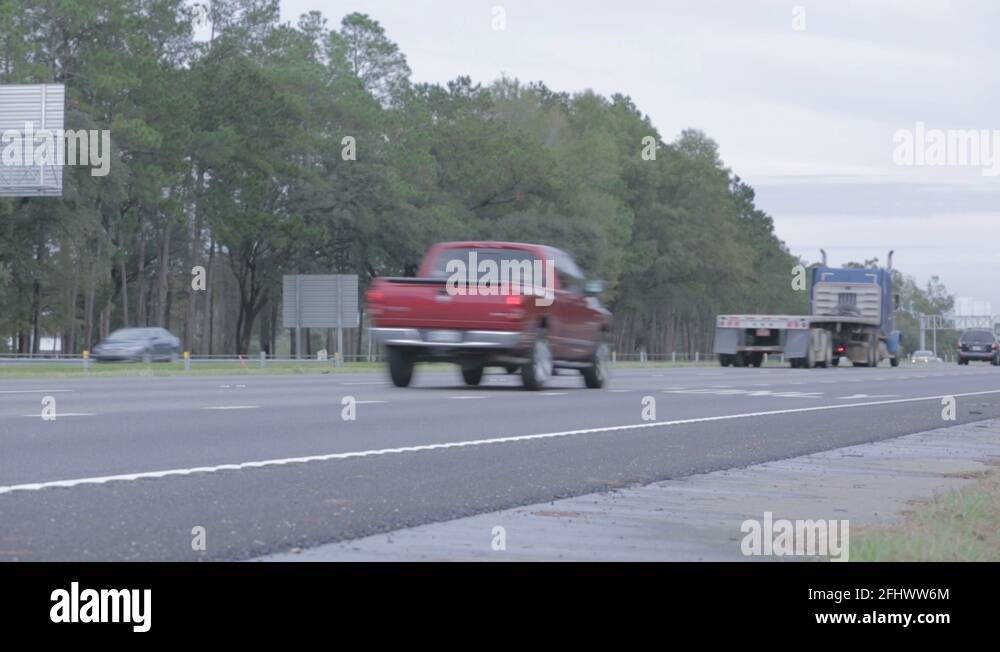 Interstate footage of cars whipping by the camera from different angles ...