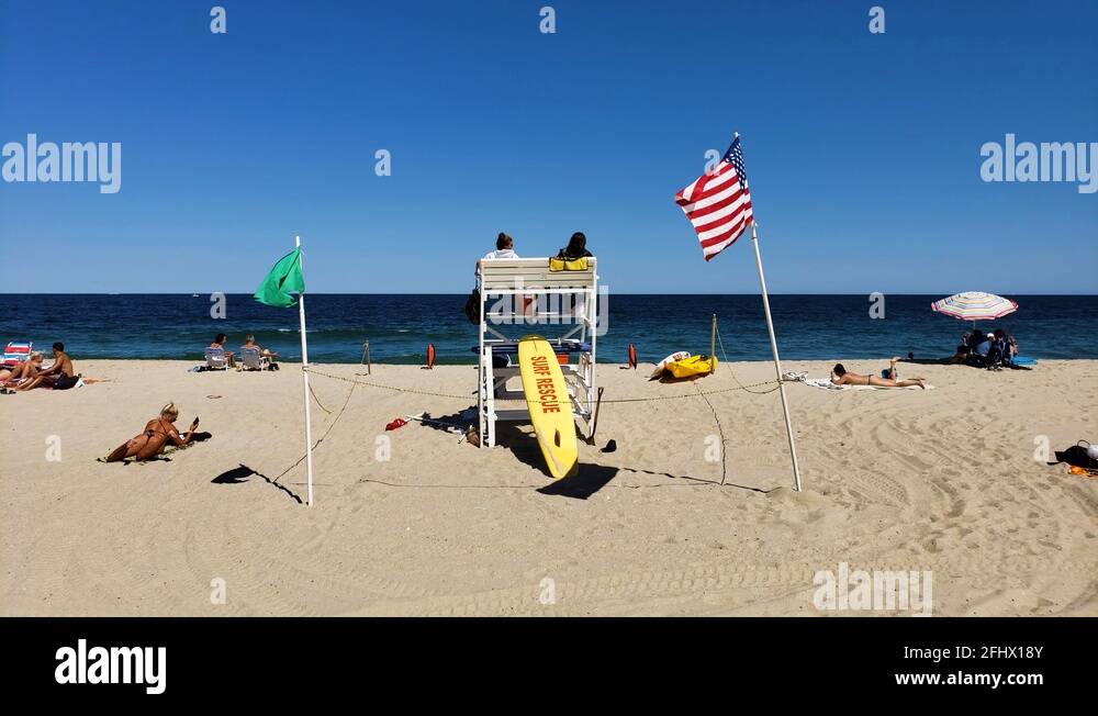Lifeguards watching over the people on the beach, back view Stock Video ...