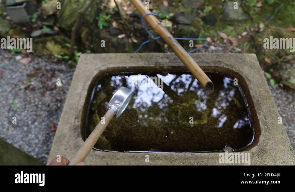 Traditional Japanese Water Ladle taking water out of basin in Japan ...