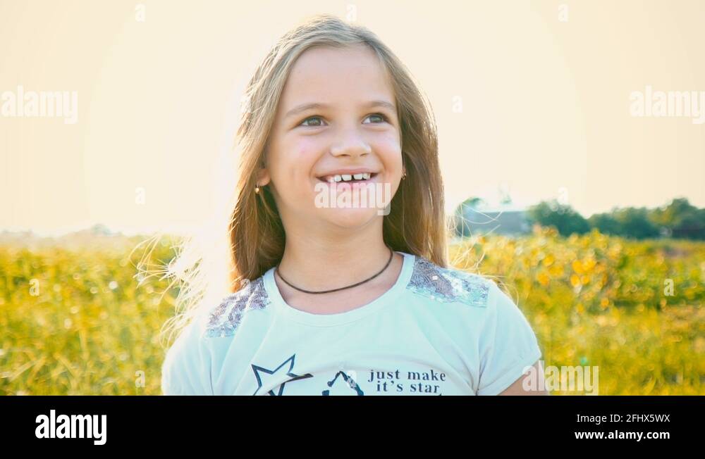 Portrait of attractive little girl with a big eyes on nature background with Stock Video Footage ...
