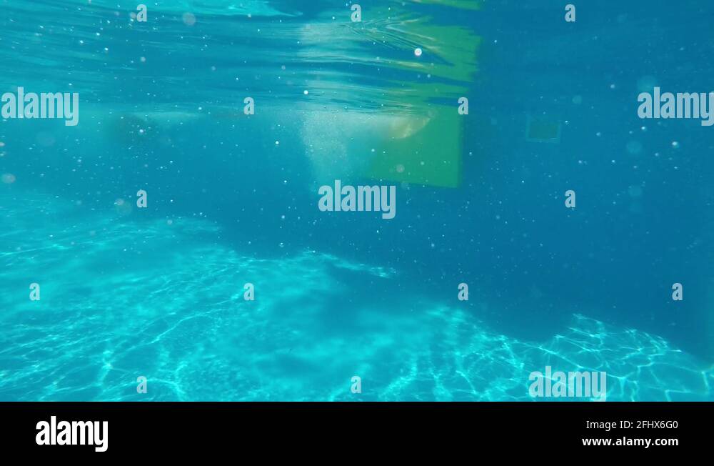 young boy in aquapark falls in water from slide, underwater,slow motion ...