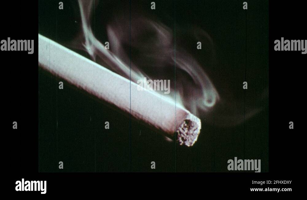 1960s: Smoke flows from burning cigarette. Smoke rises from cigarettes ...