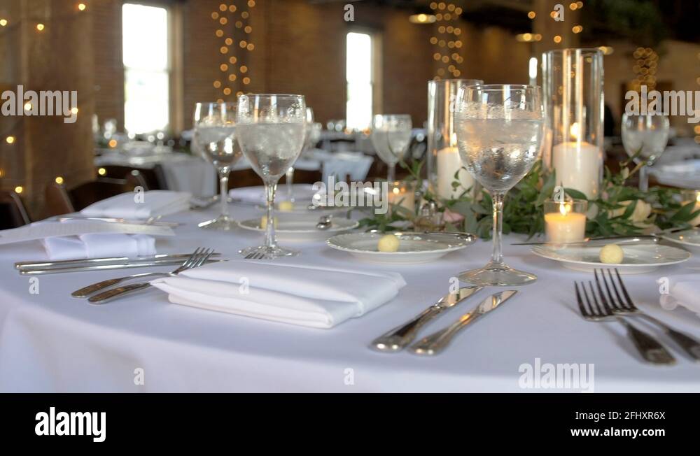 Fancy Dinner Table Setup at a Banquet Inside of a Rustic Brick Building ...